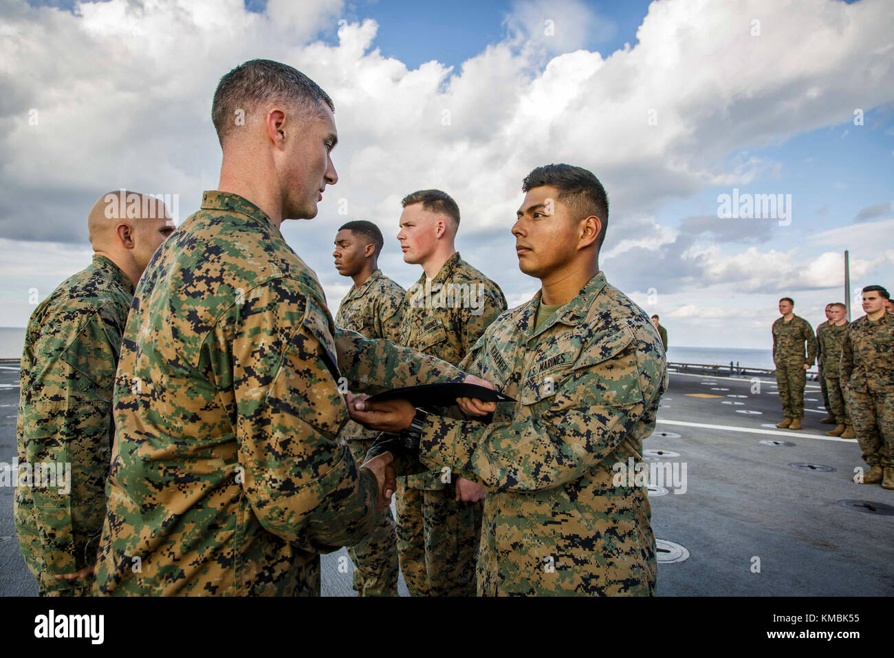 U.S. Marine Corps Cpl. Hunter S. Kraemer, right, an assault amphibious ...