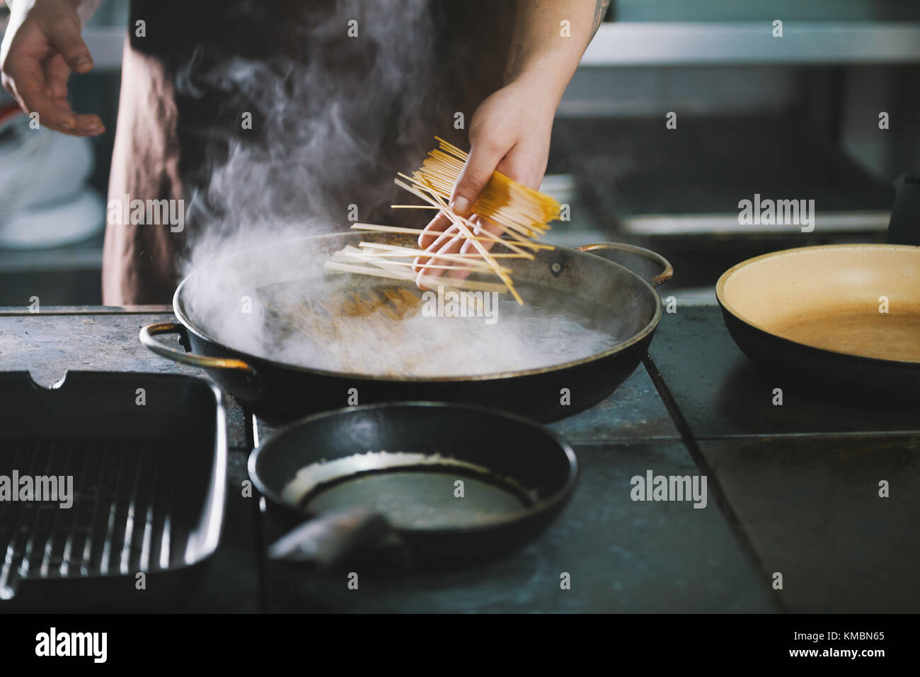 Professional cooking spaghetti in restaurant Stock Photo - Alamy