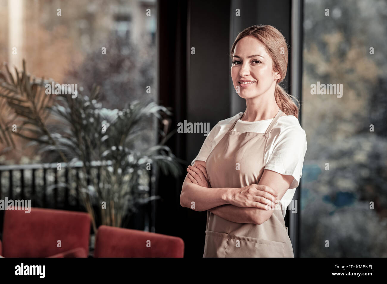 Smart cheerful waitress looking satisfied with her working day Stock ...