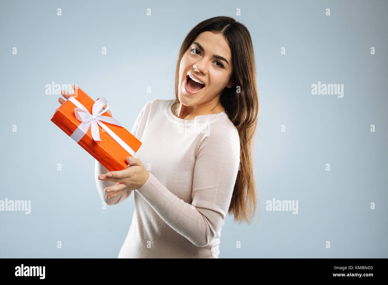 Playful female demonstrating red box Stock Photo - Alamy