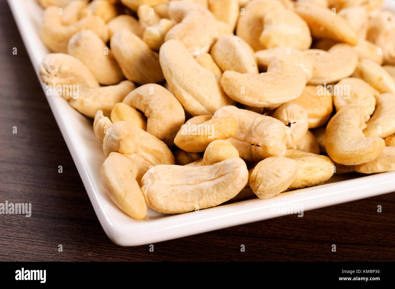 Pile of roasted cashew nuts splashed on the table Stock Photo - Alamy