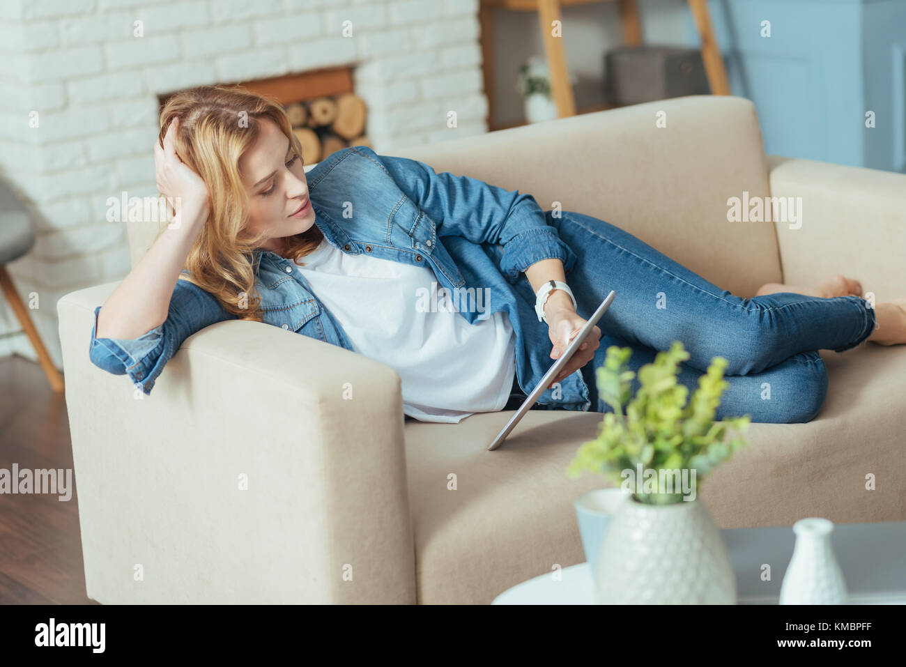 Relaxing young woman feeling good while reading Stock Photo - Alamy