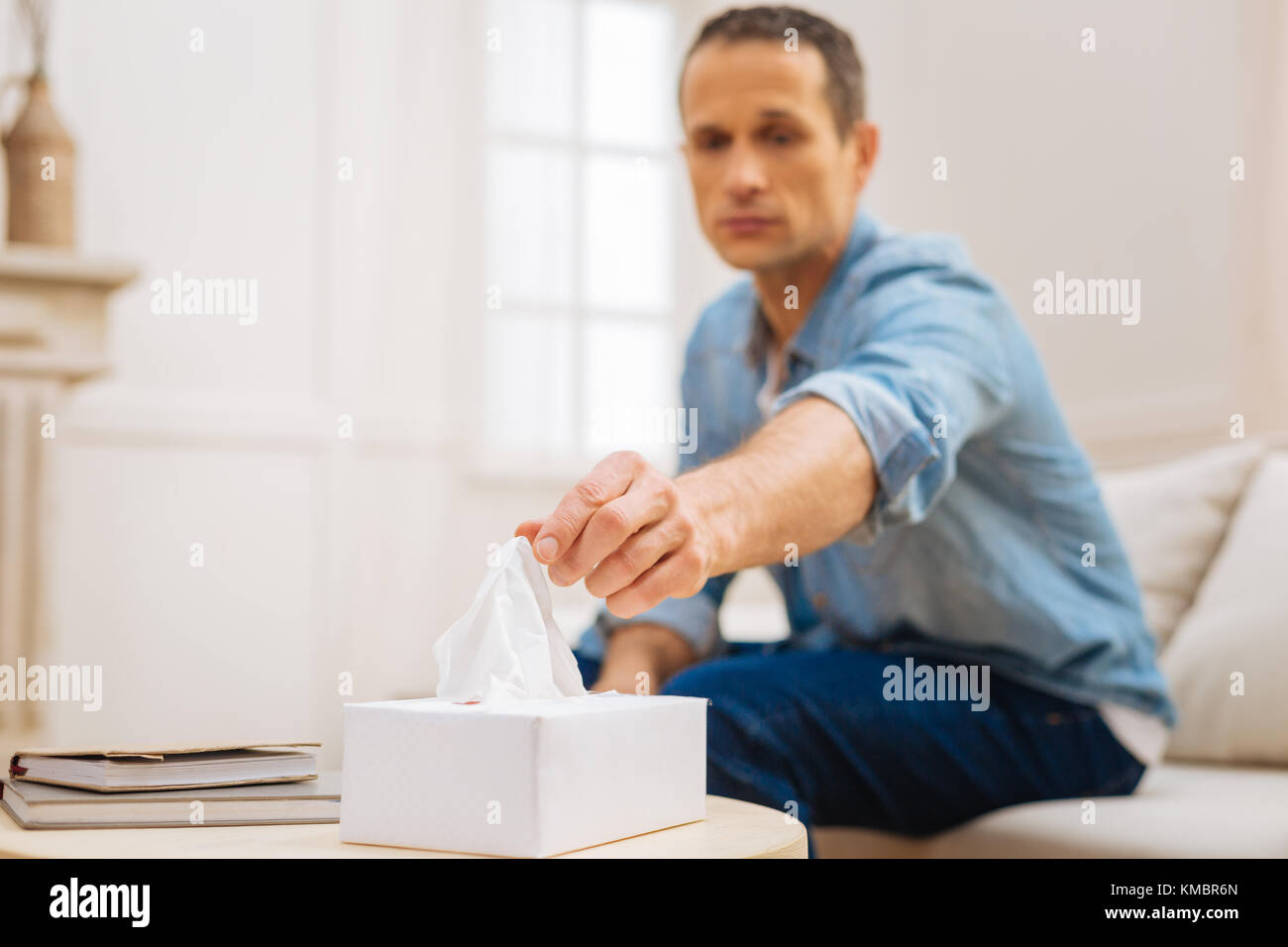 Handsome tragic man crying during the therapy Stock Photo - Alamy