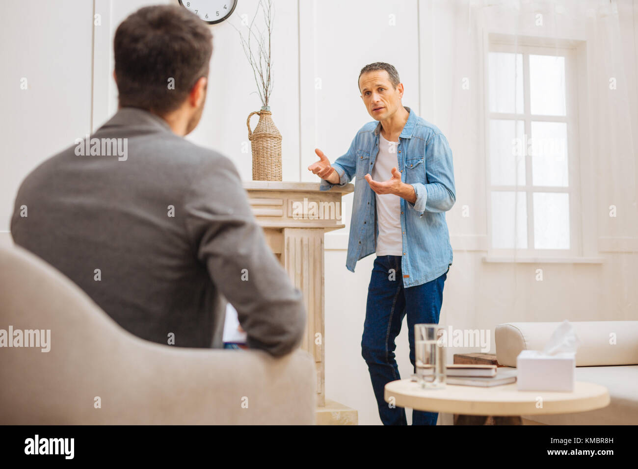 Stressful male patient expressing his pain Stock Photo - Alamy