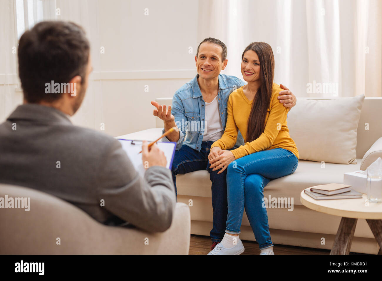 Happy couple visiting psychologist Stock Photo - Alamy