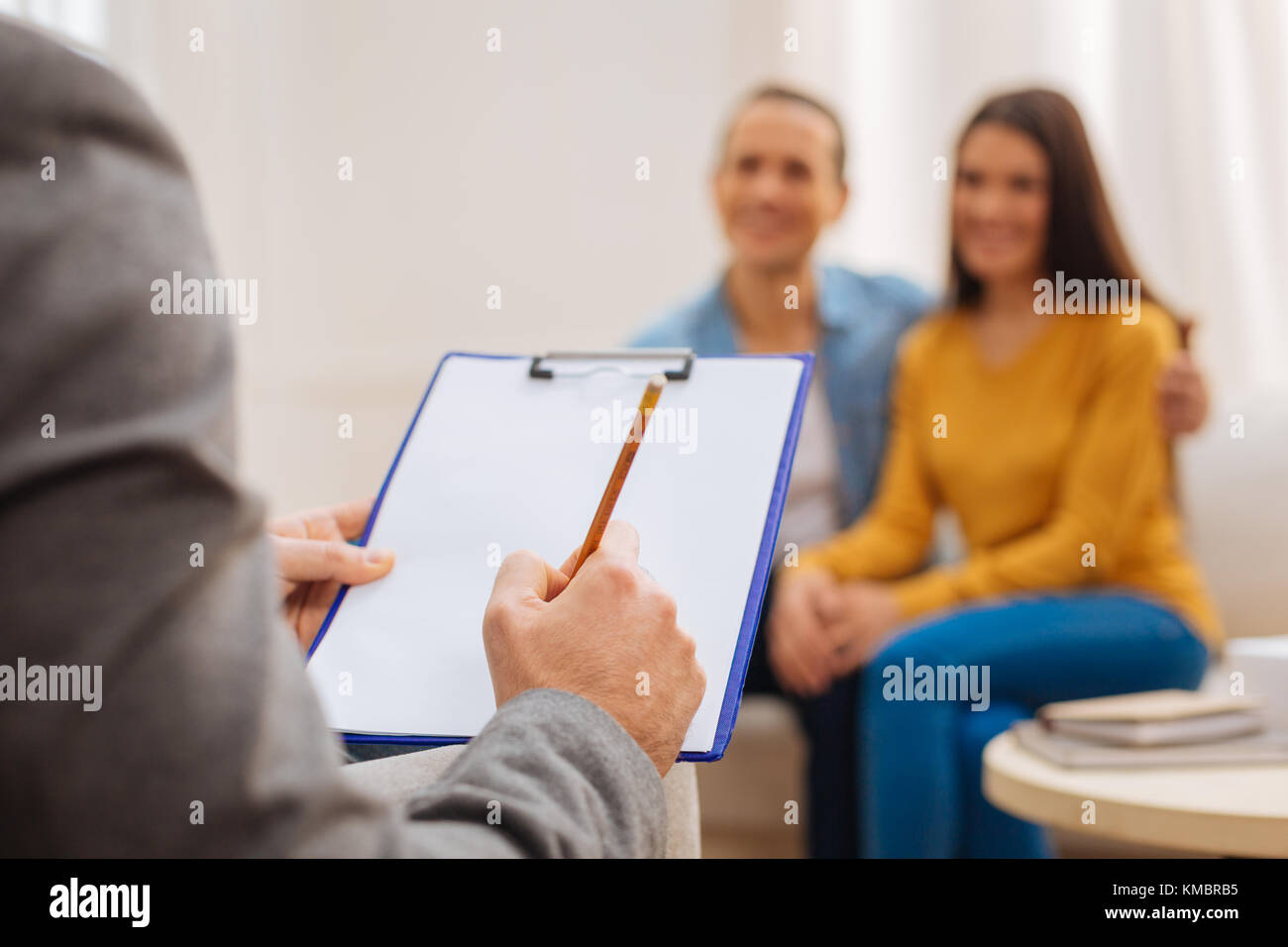 Psychologist writing down thoughts during therapy Stock Photo - Alamy