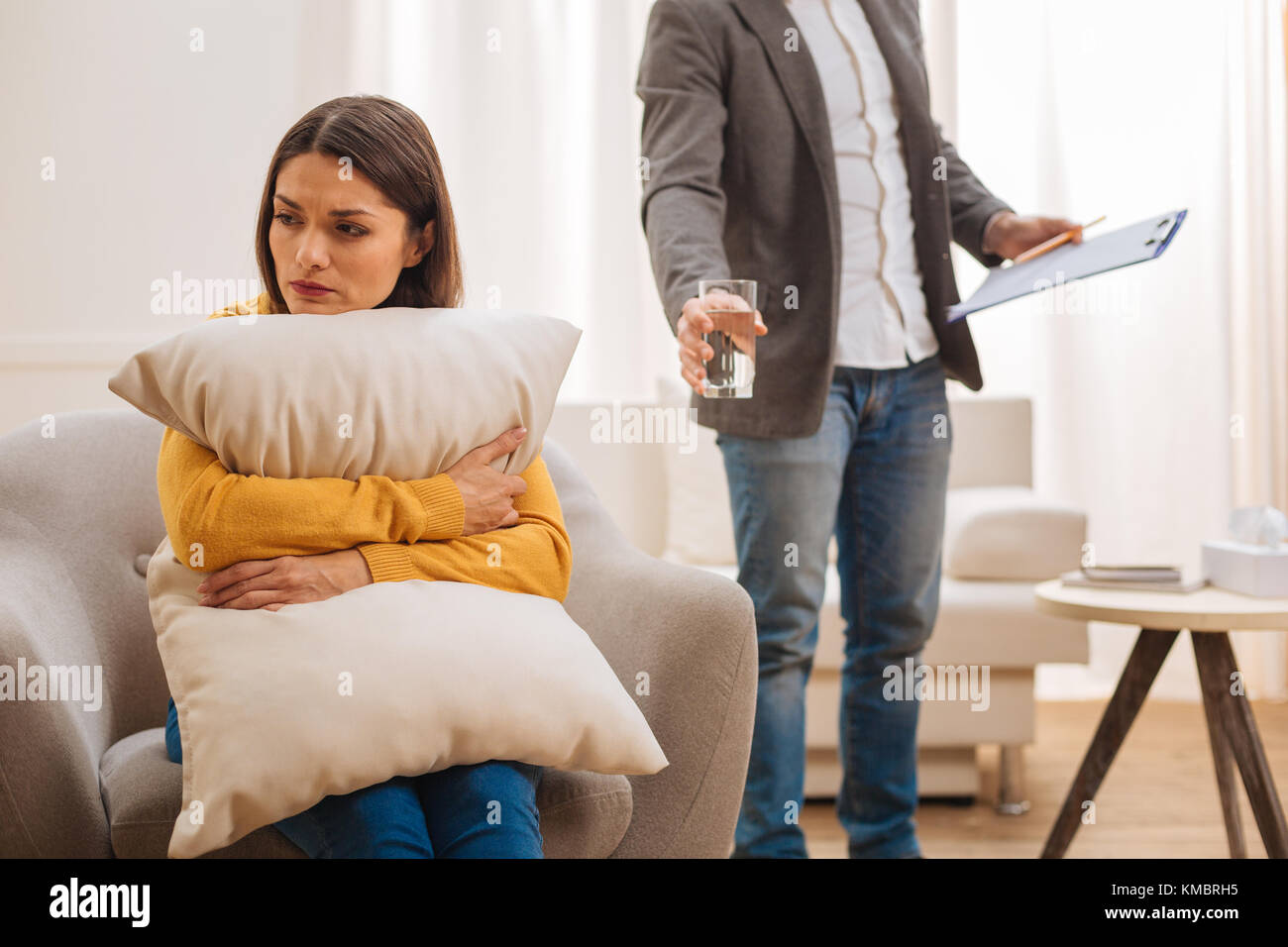 Nice amazing woman hugging cushion during therapy Stock Photo - Alamy