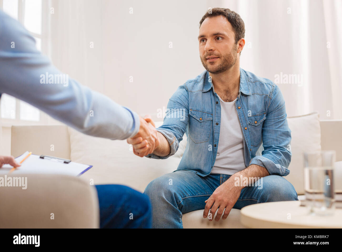 Pleasant good looking man visiting psychologist Stock Photo - Alamy