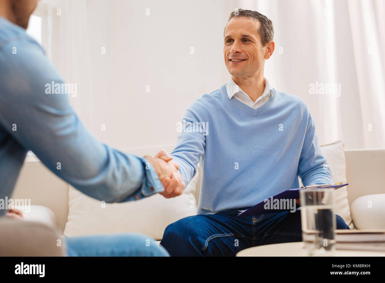 Happy vigorous man making acquaintance with psychologist Stock Photo ...
