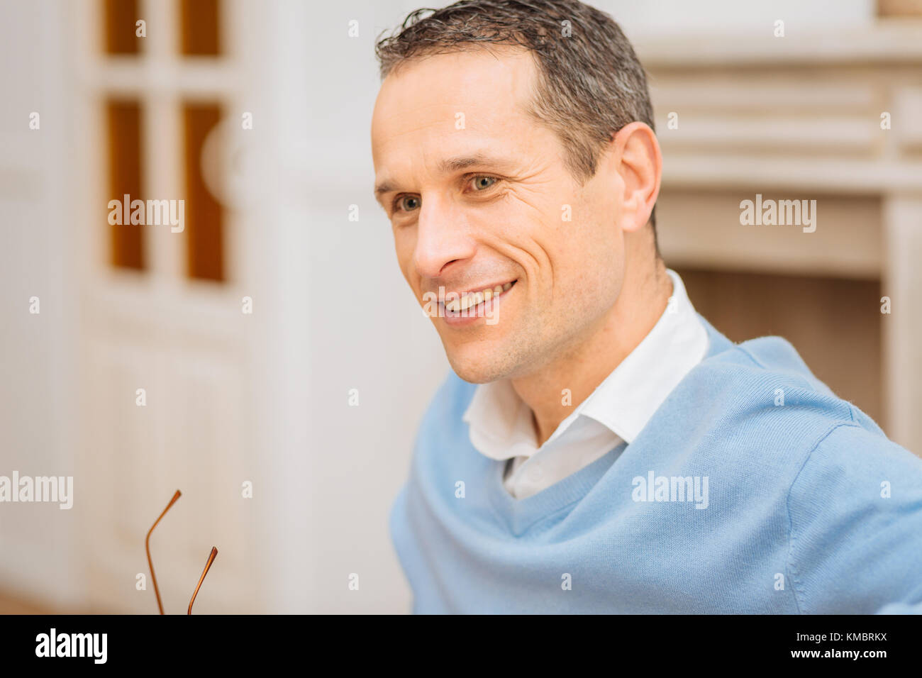 Joyful nice man hearing good news Stock Photo - Alamy