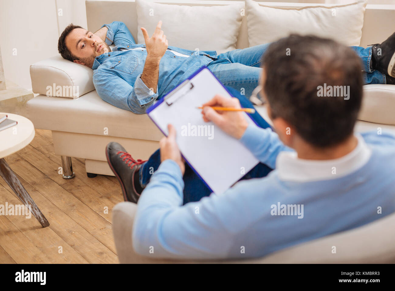 Relaxed calm man describing his emotional state Stock Photo - Alamy
