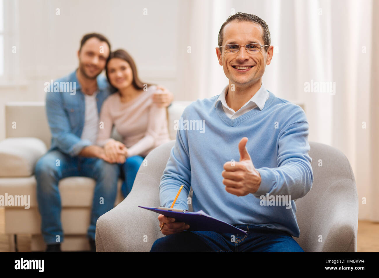 Smiling attractive psychologist does his job Stock Photo - Alamy
