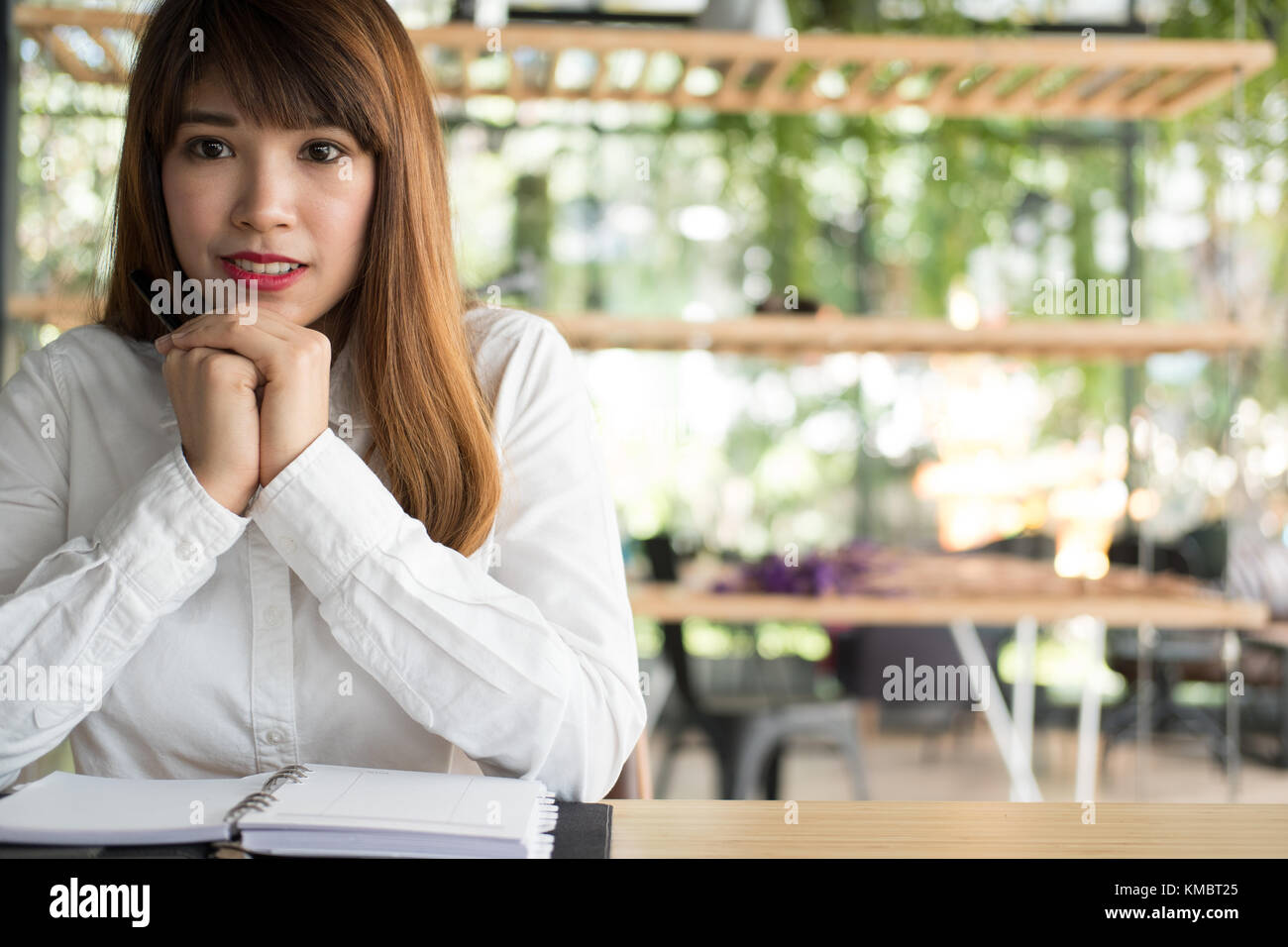 asian woman sit in cafe. female student with notebook in coffee shop ...