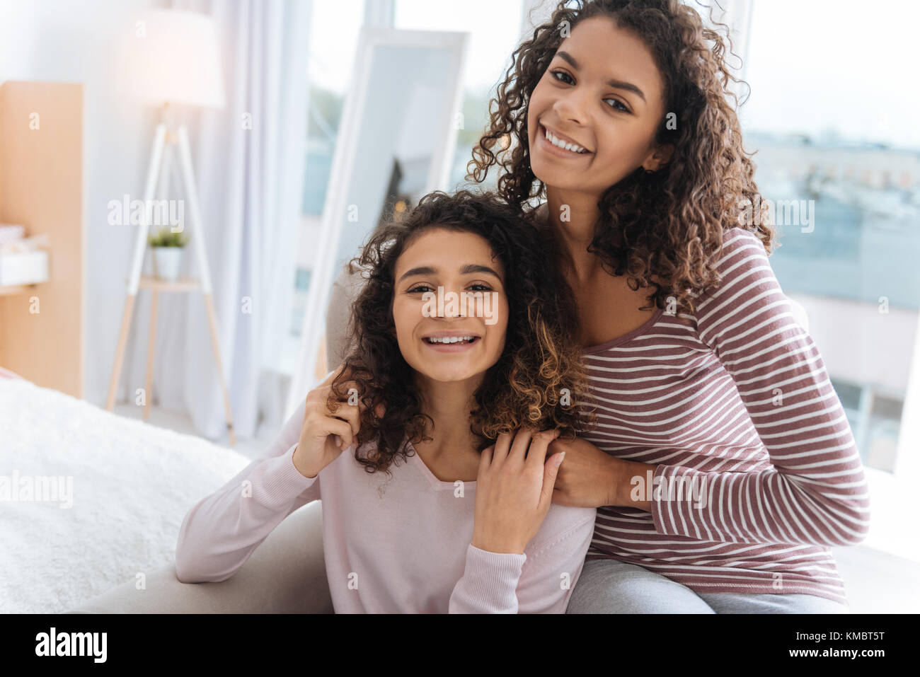 Supportive siblings posing for camera and smiling cheerfully Stock ...