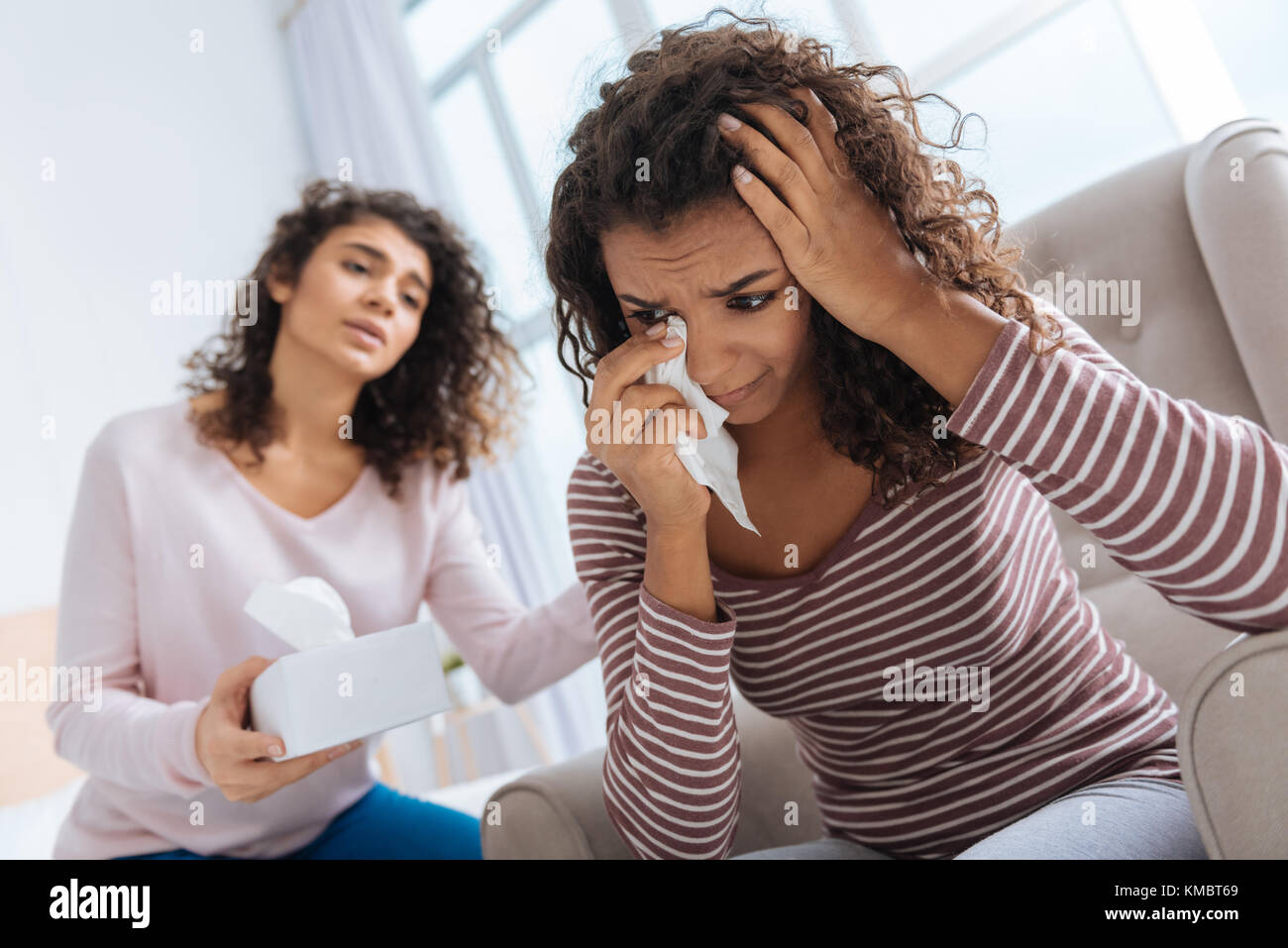 Thoughtful girl calming her depressed sister crying Stock Photo - Alamy