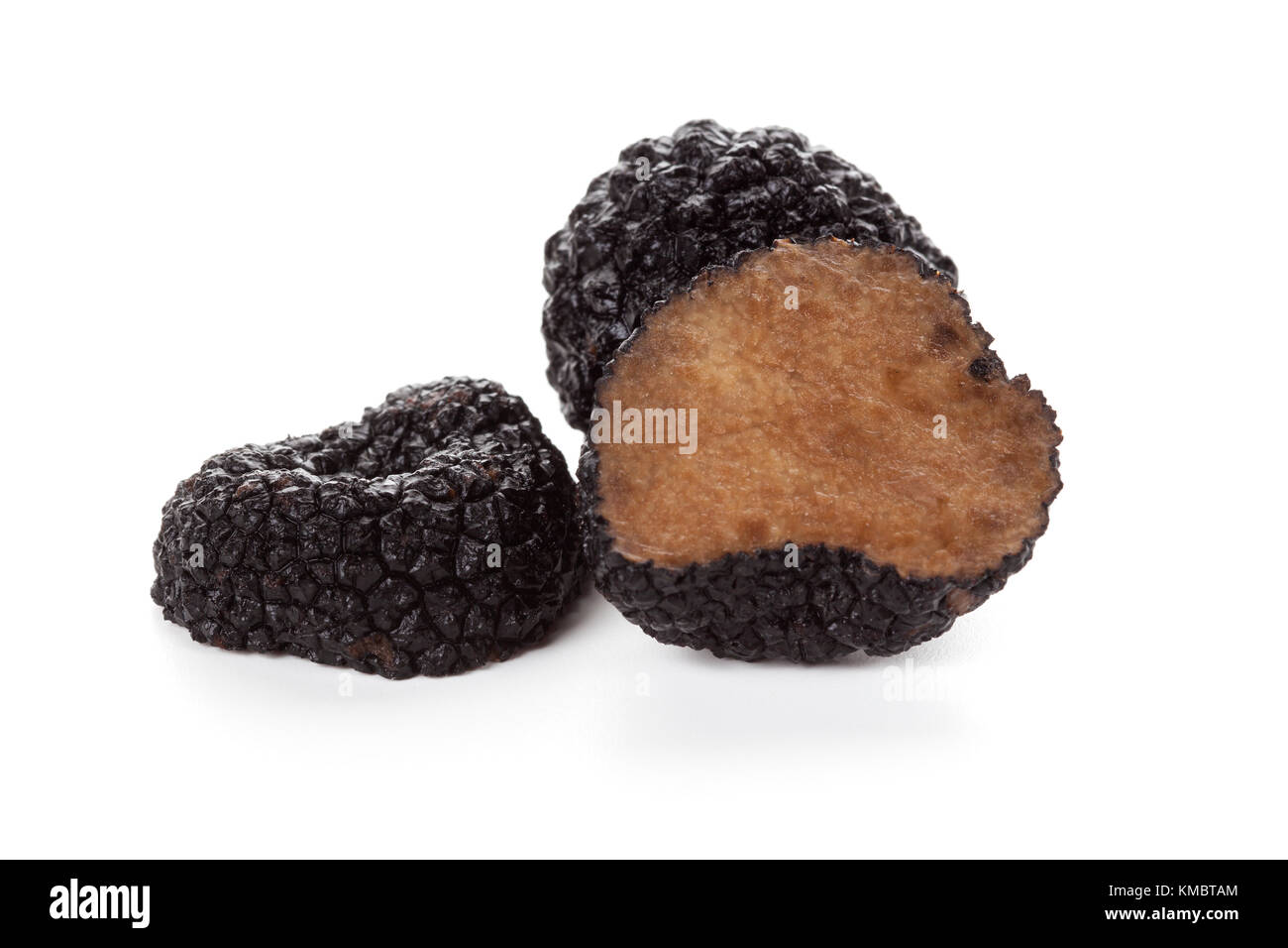 Wohle and halved black truffles, Tuber Indicum, isolated on white ...