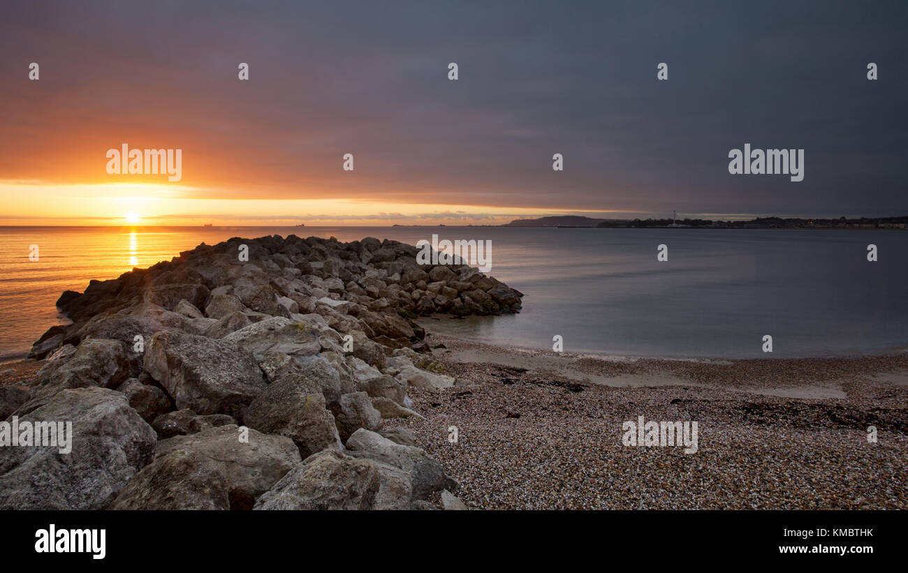 Sunset over the beach in Dorset Stock Photo - Alamy