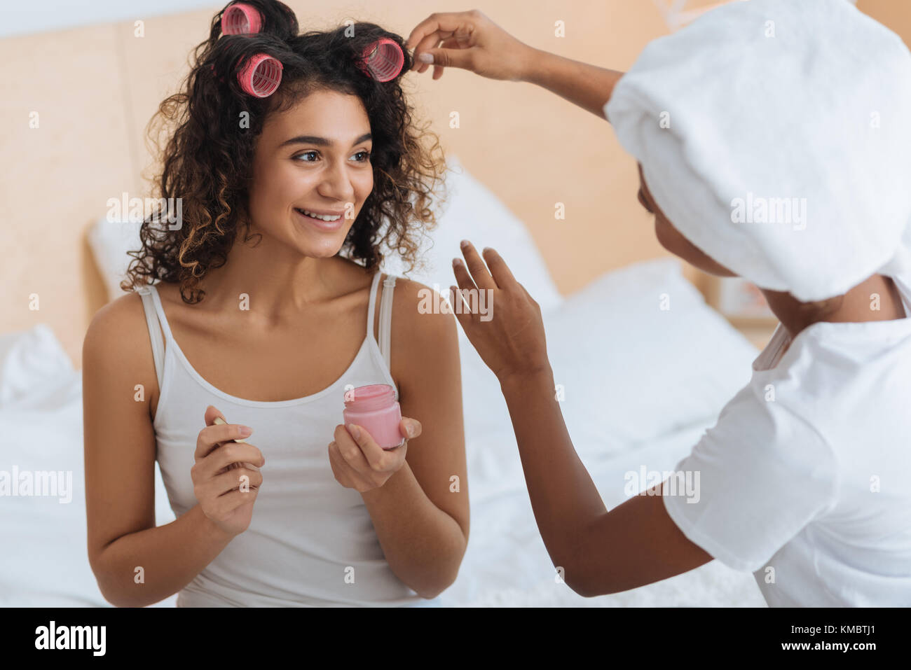 Beautiful girls getting ready and curling hair Stock Photo - Alamy