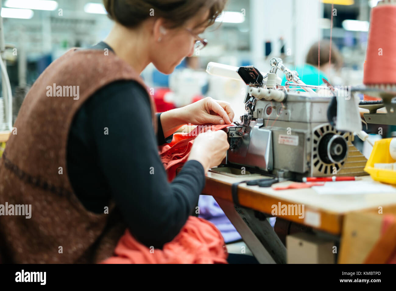 Woman working in textile industry Stock Photo - Alamy