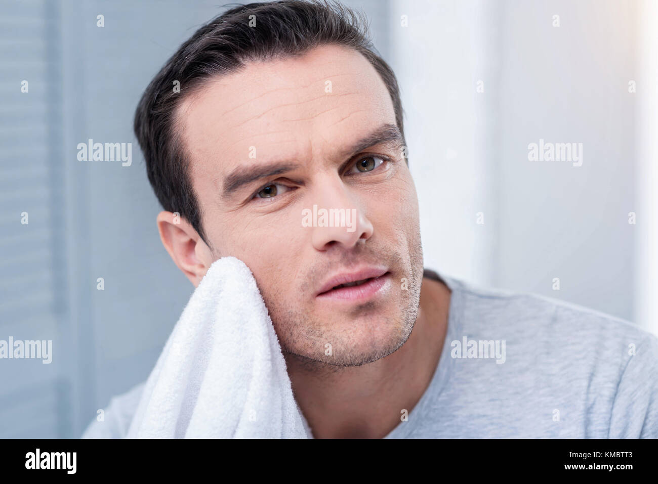 Appealing pensive man getting ready for work Stock Photo - Alamy
