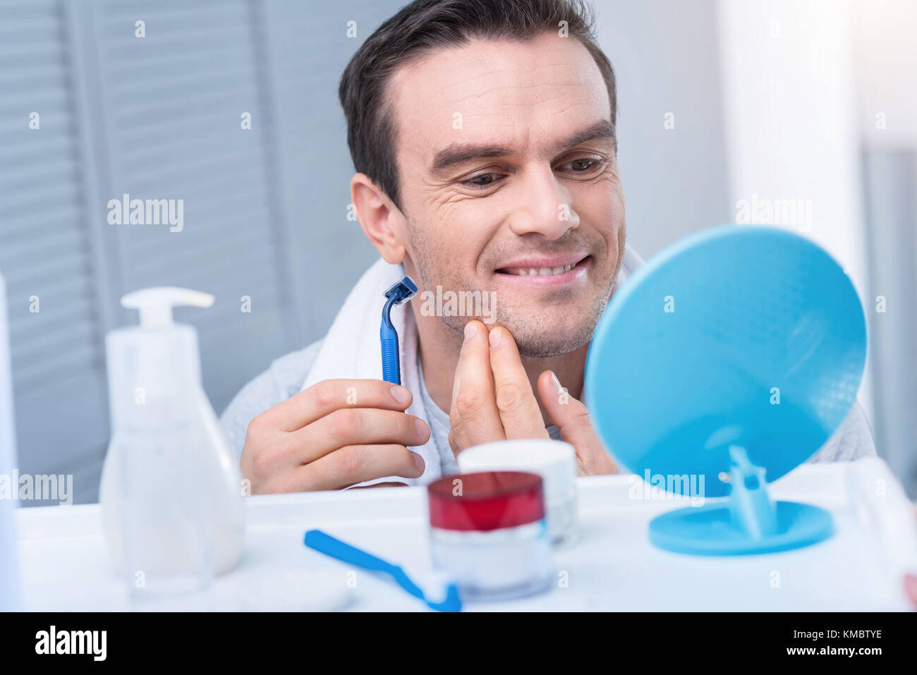 Concentrated earnest man shaving before work Stock Photo - Alamy