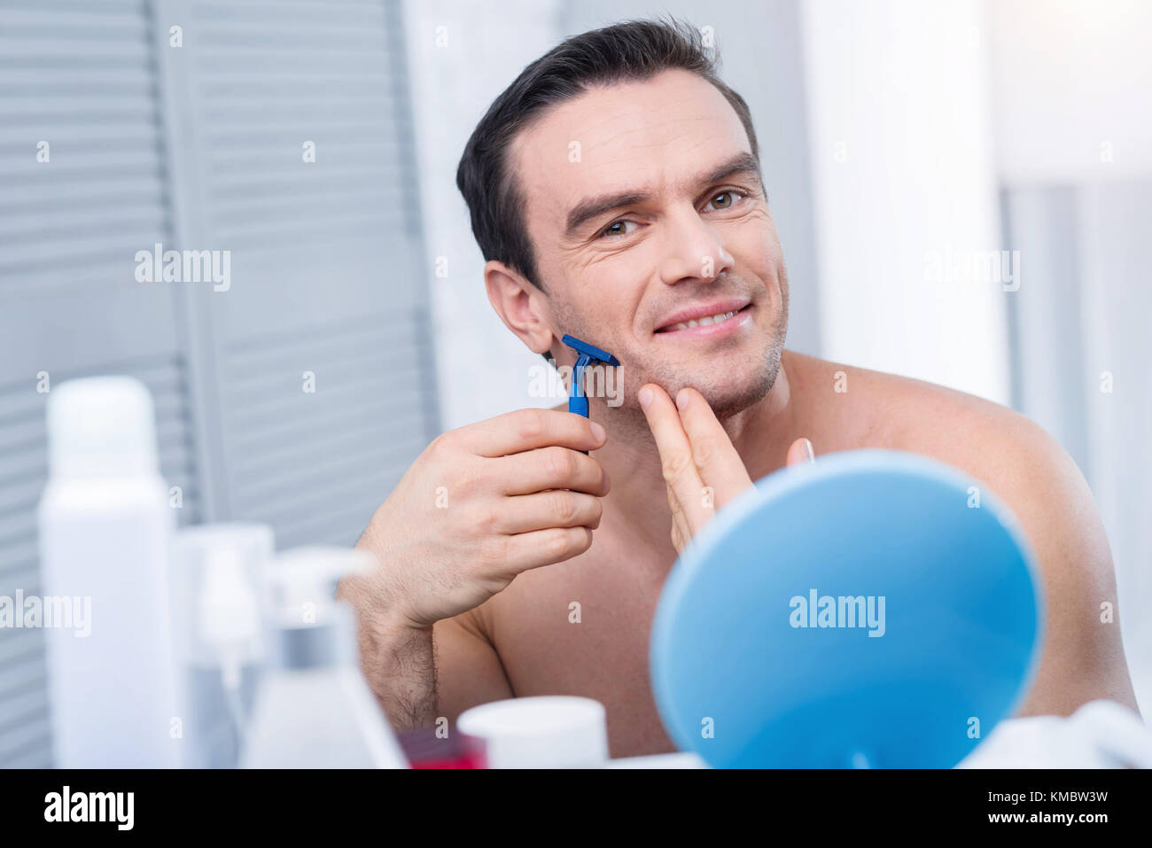 Cheerful glad man getting ready for work Stock Photo - Alamy