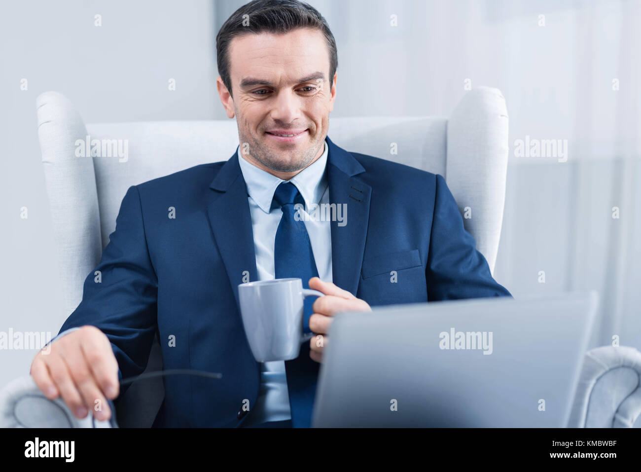 Budding happy man examining statistics Stock Photo - Alamy