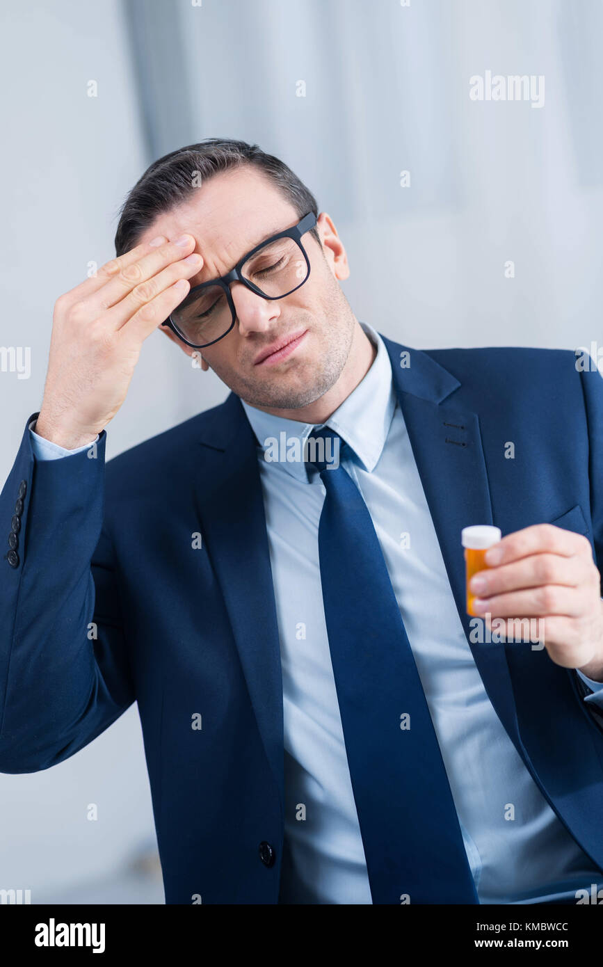 Desperate calm man taking medication Stock Photo - Alamy