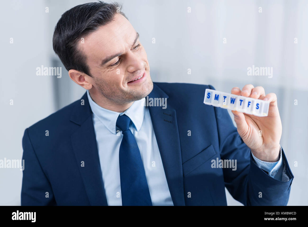 Happy positive man taking pills Stock Photo - Alamy