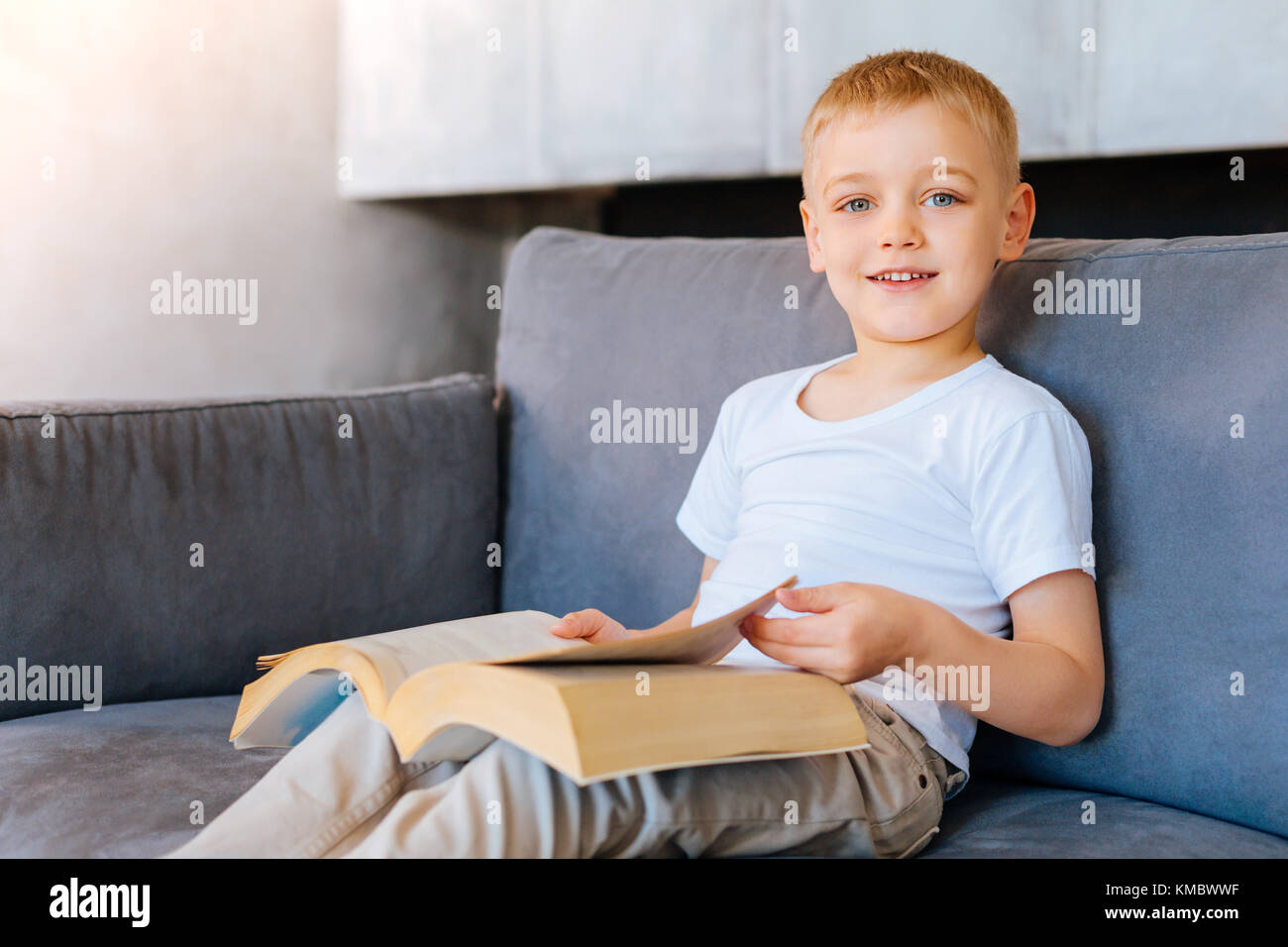 Nice smart boy holding a book Stock Photo - Alamy