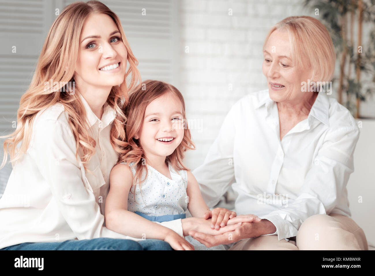 Happy delighted woman holding her daughter Stock Photo - Alamy