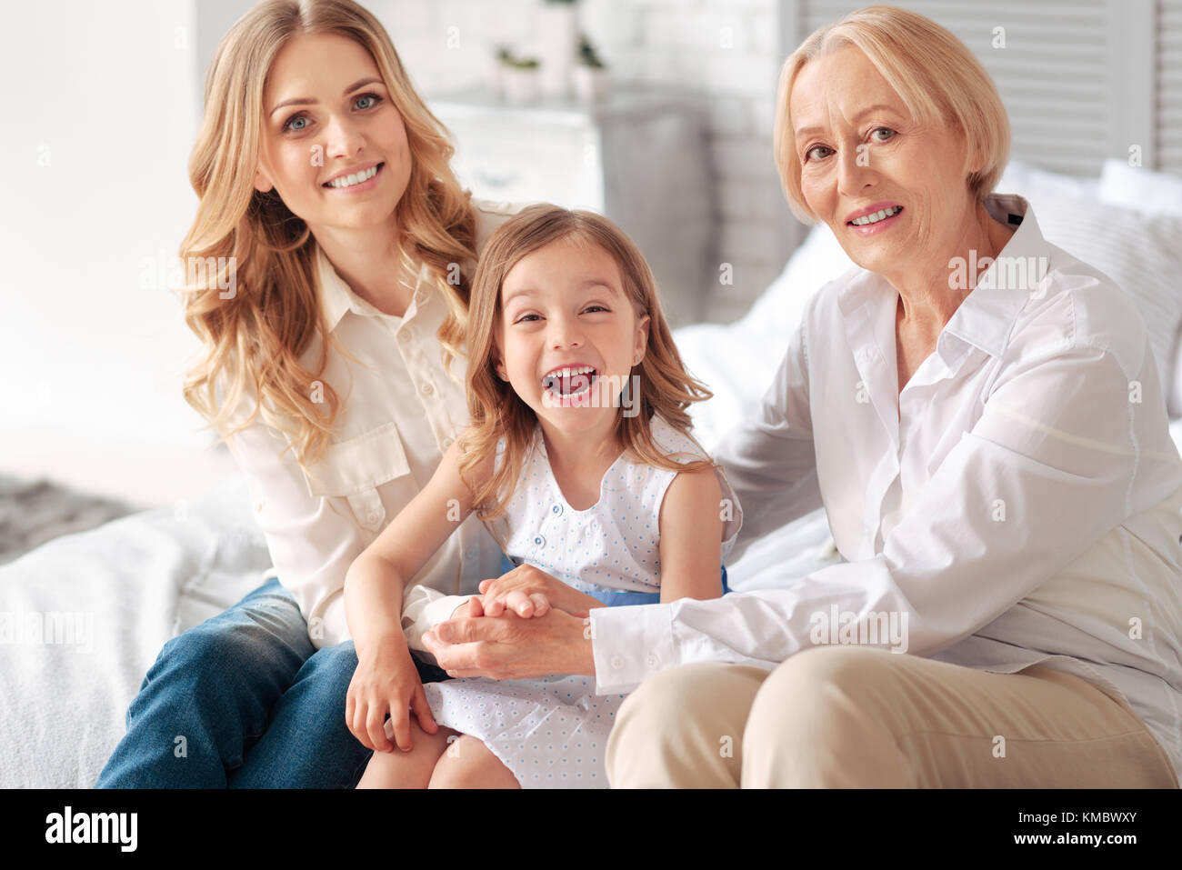 Delighted positive family enjoying their time together Stock Photo - Alamy