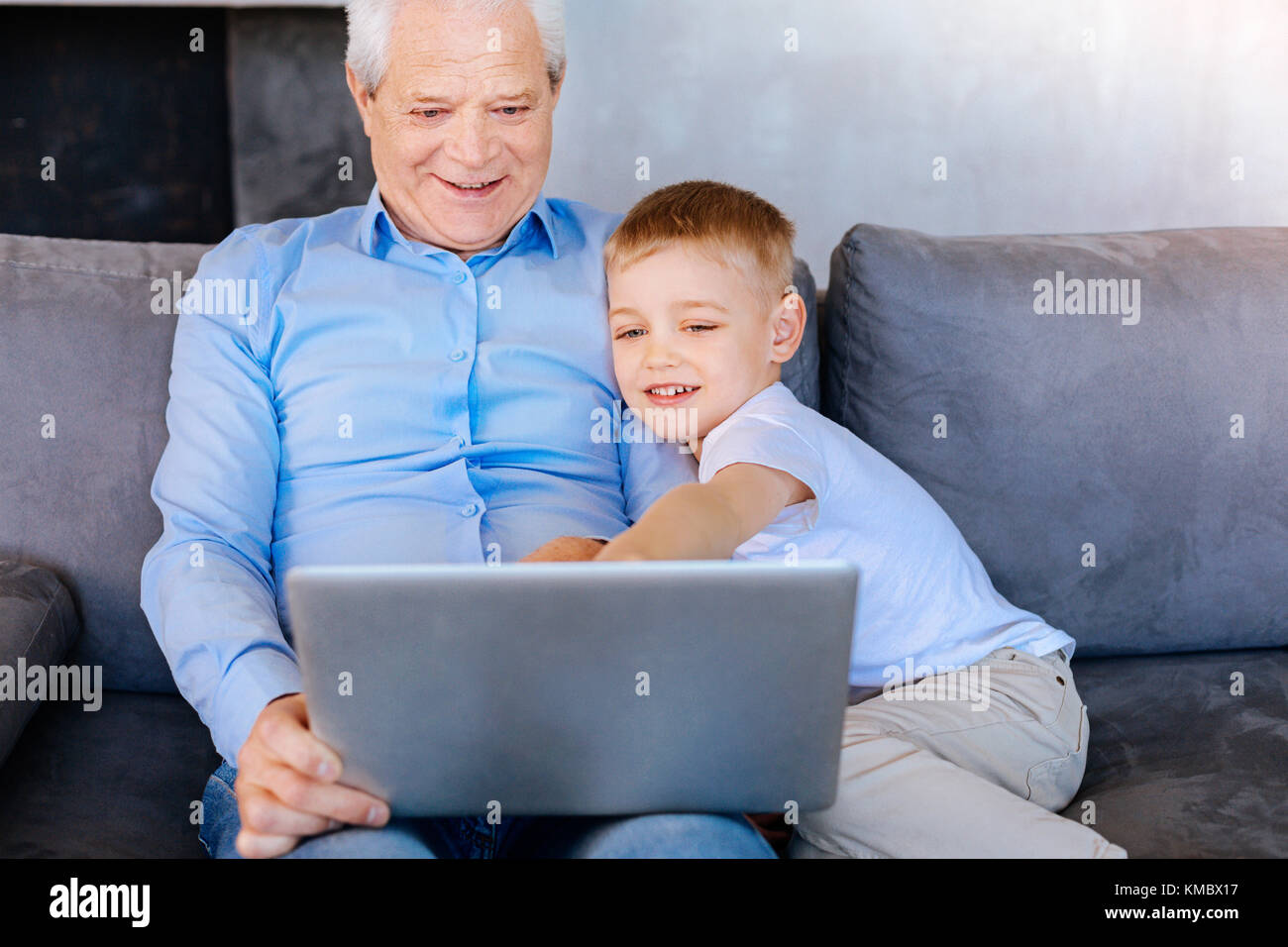 Joyful cute boy pointing at the laptop screen Stock Photo - Alamy