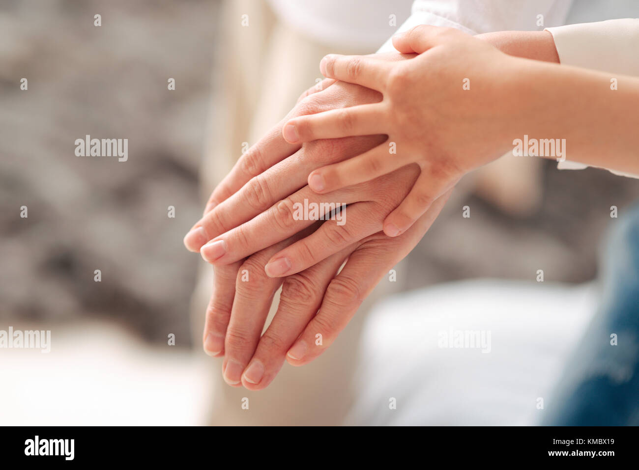 Hands of three generations being held together Stock Photo - Alamy