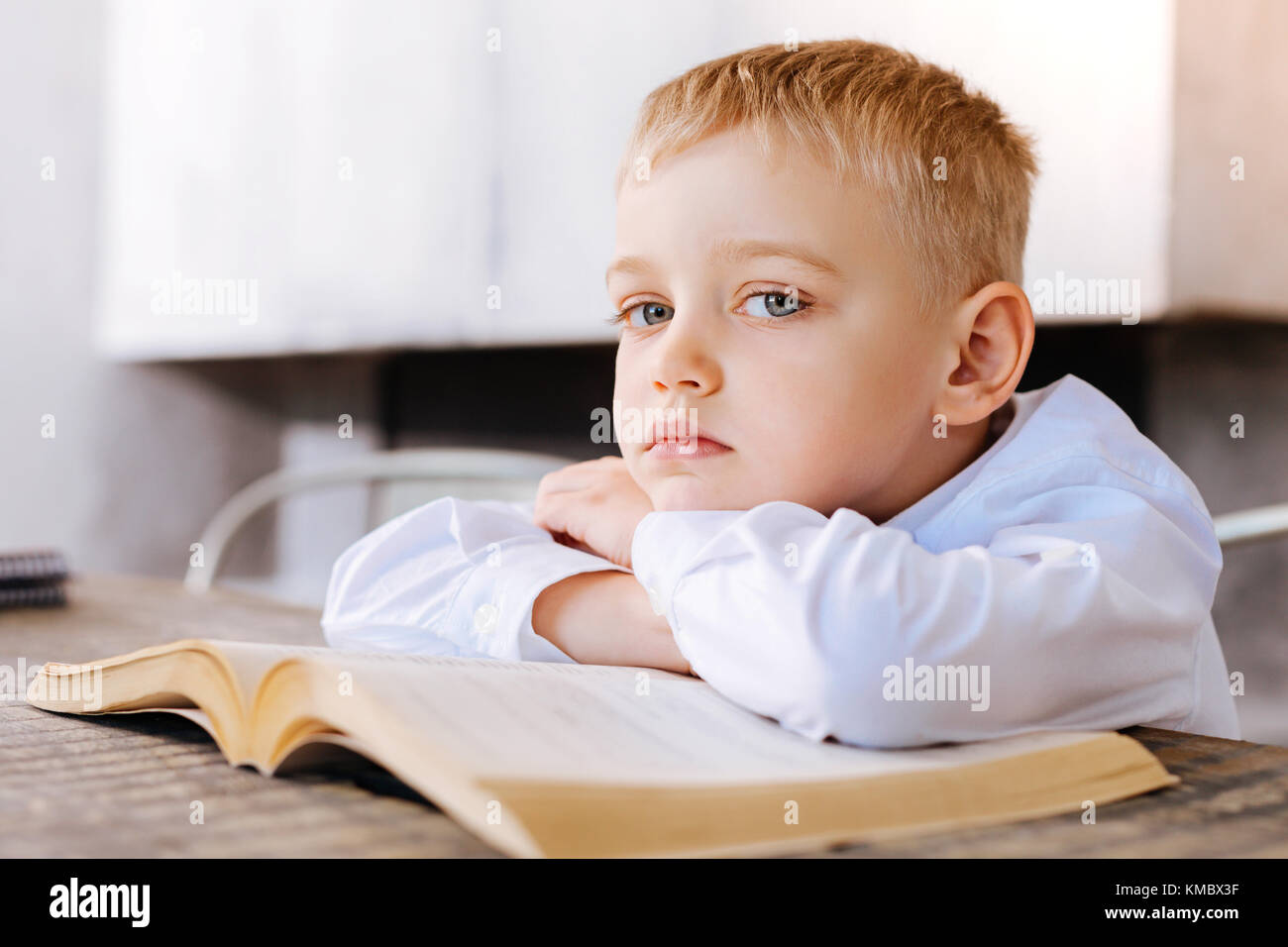 Nice unhappy boy feeling bored Stock Photo - Alamy