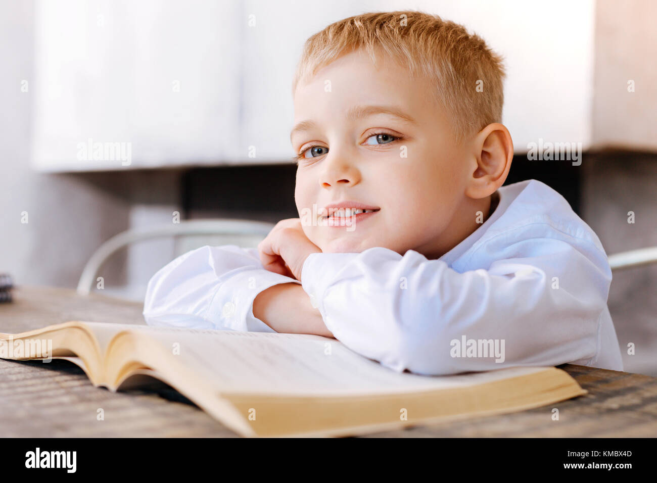 Delighted nice boy smiling Stock Photo - Alamy