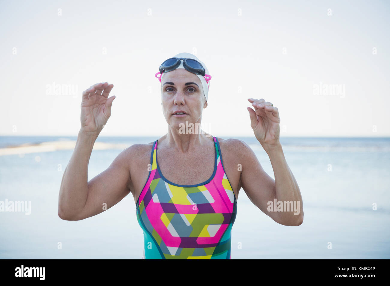 Portrait serious mature female open water swimmer at ocean Stock Photo ...