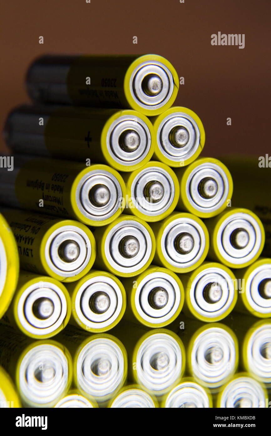 Stack of yellow AA batteries close up, electricity storage concept ...