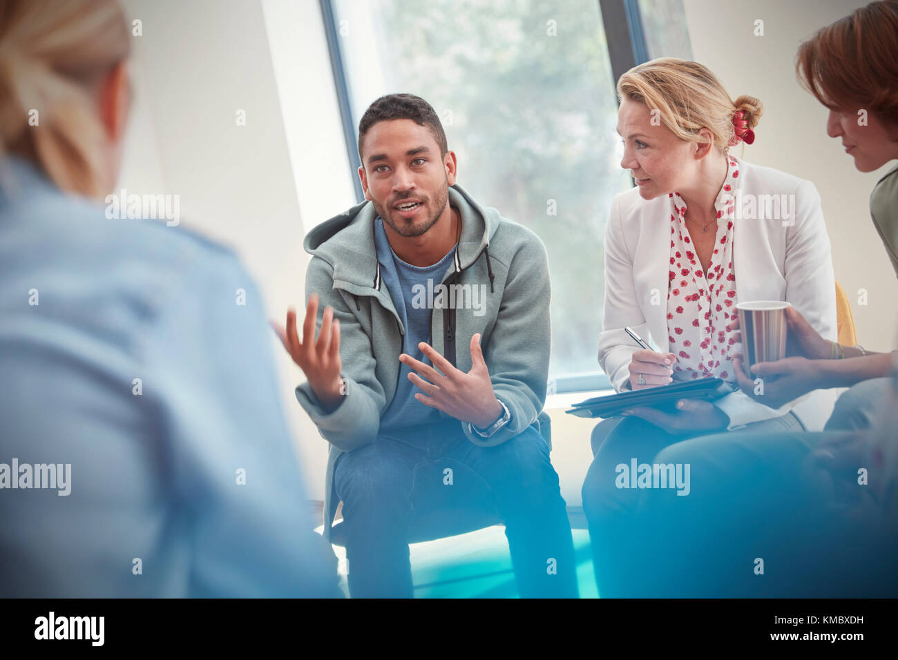 Man talking in group therapy session Stock Photo - Alamy