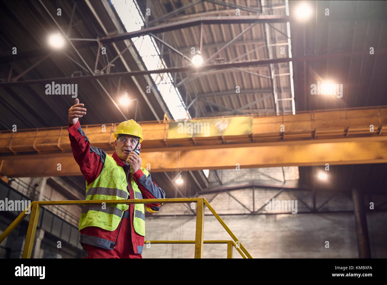 Steelworker talking,using walkie-talkie on platform in steel mill Stock ...