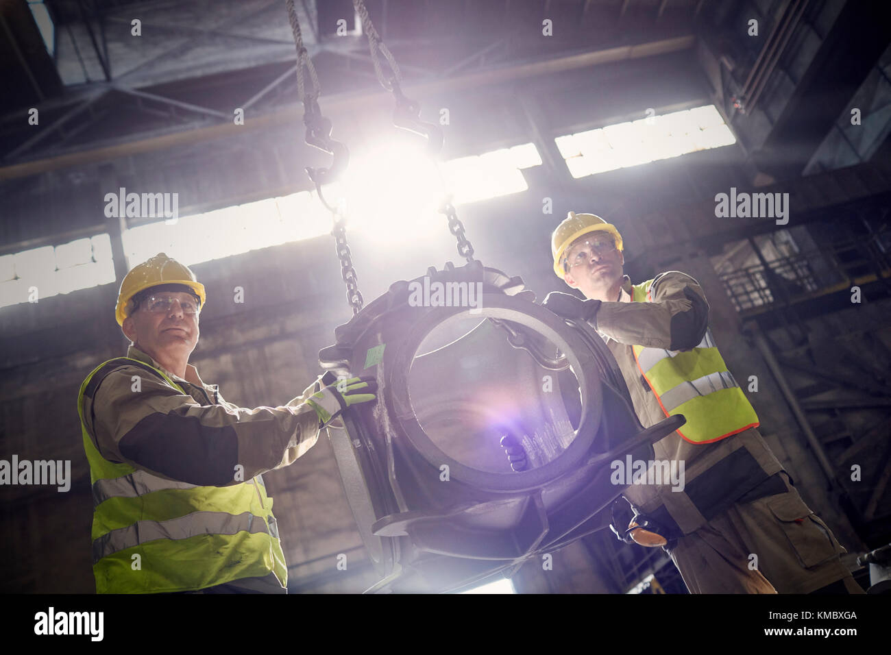 Steelworkers moving steel part in steel mill Stock Photo - Alamy