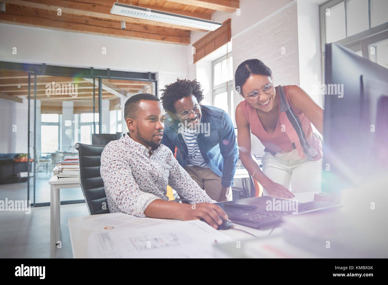 Graphic designers working at computer with graphics tablet in office ...