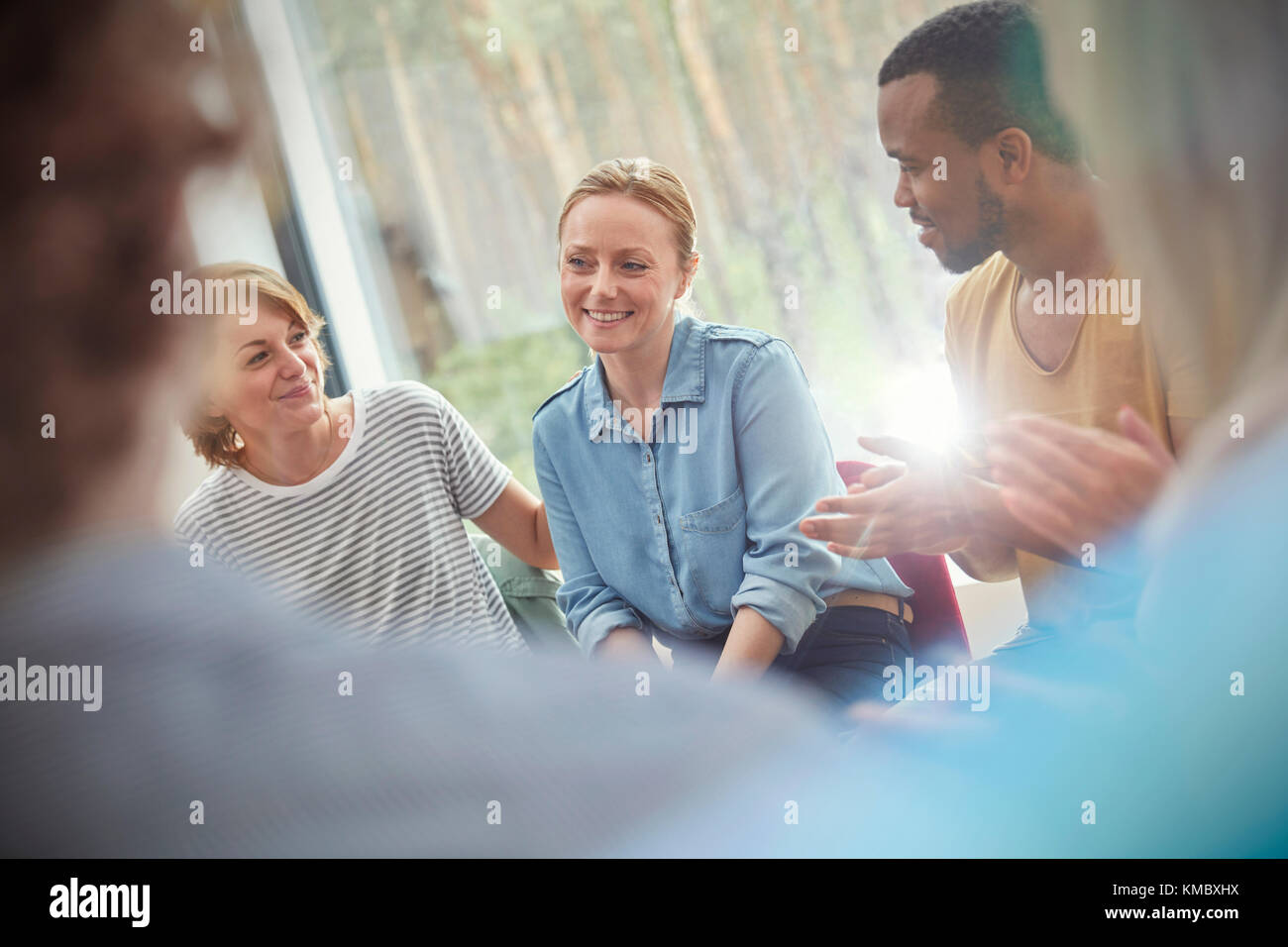 People clapping for woman in group therapy session Stock Photo - Alamy