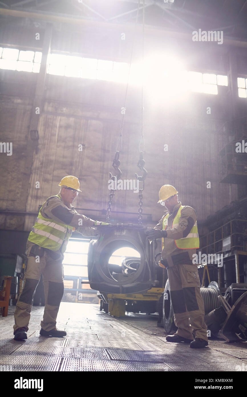 Steelworkers moving steel part in steel mill Stock Photo - Alamy