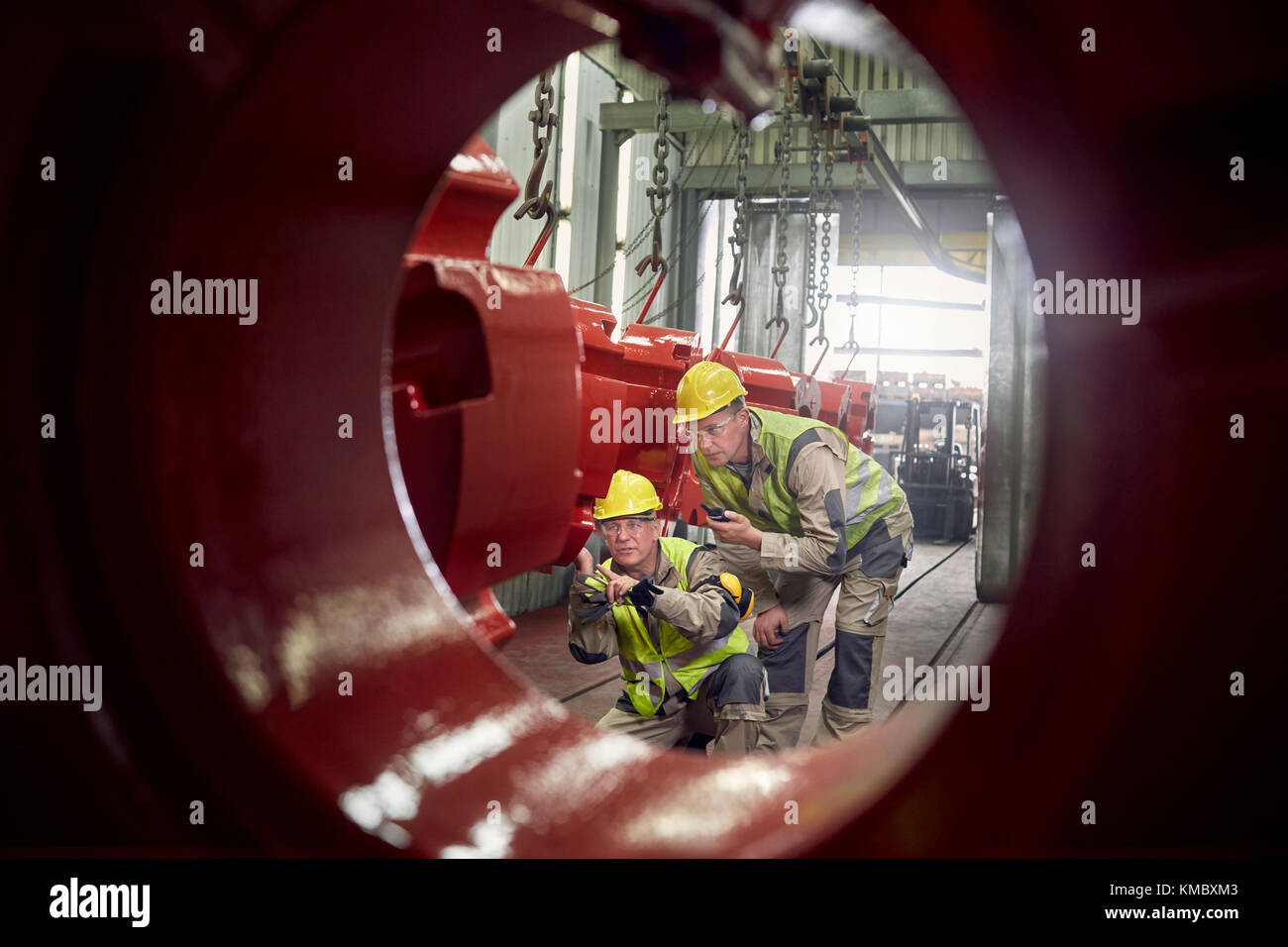 Steelworkers examining steel equipment in steel mill Stock Photo - Alamy