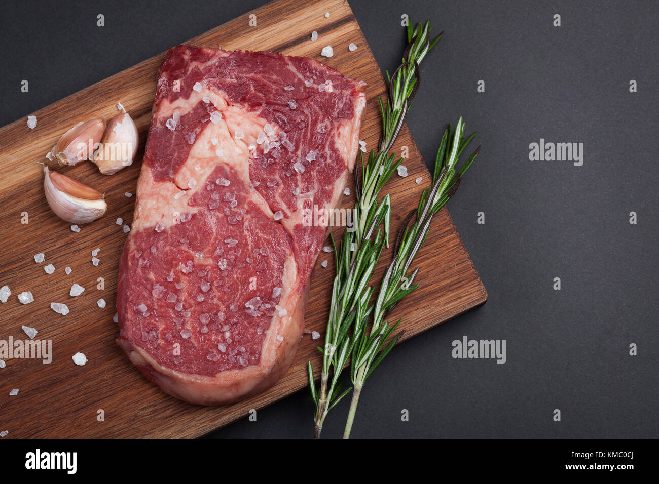 A fresh raw piece of black angus marbled meat with spices close-up on a ...