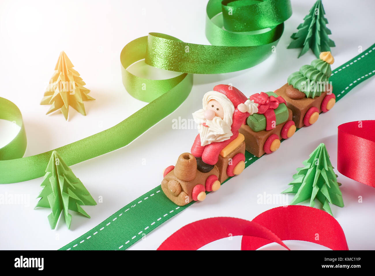 Santa claus driving train on ribbon with pulling christmas trees and ...