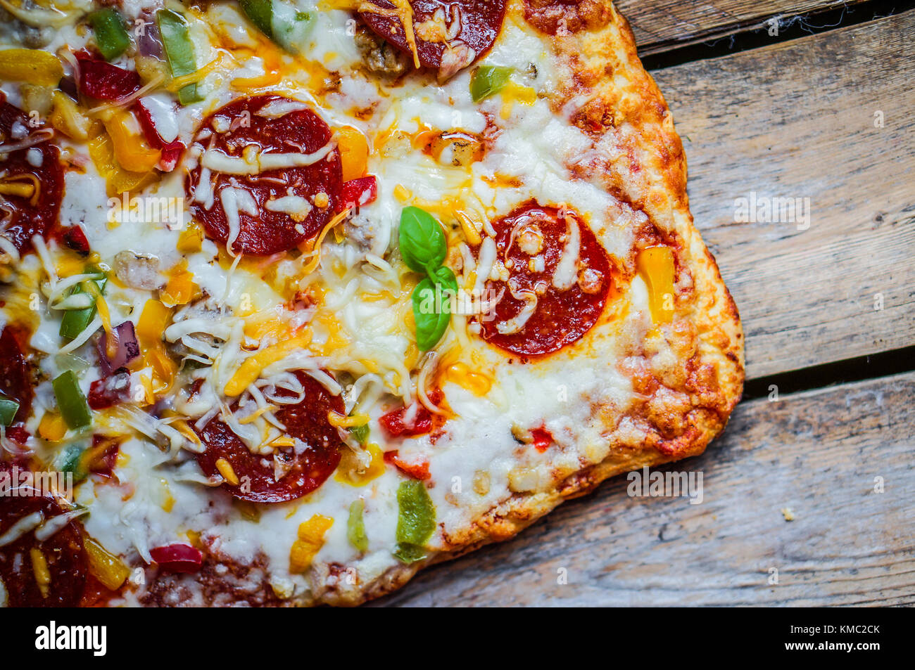 Square Pepperoni Pizza On Rustic Wooden Background Stock Photo - Alamy