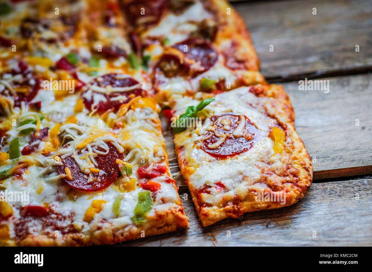 Square Pepperoni Pizza On Rustic Wooden Background Stock Photo - Alamy