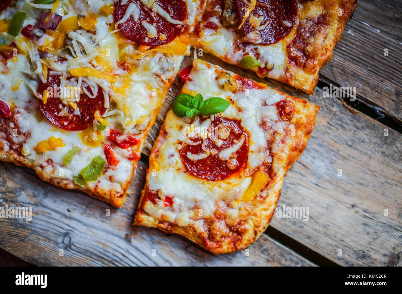 Square Pepperoni Pizza On Rustic Wooden Background Stock Photo - Alamy